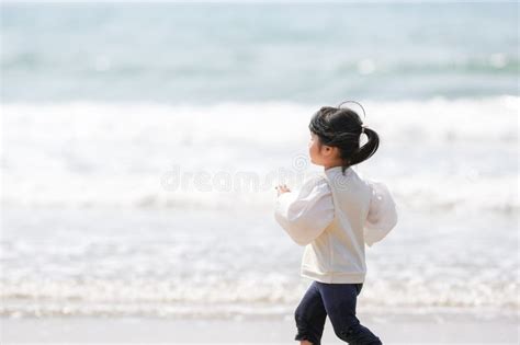 In Early March A 3 Year Old Japanese Girl In A White Outfit Runs And