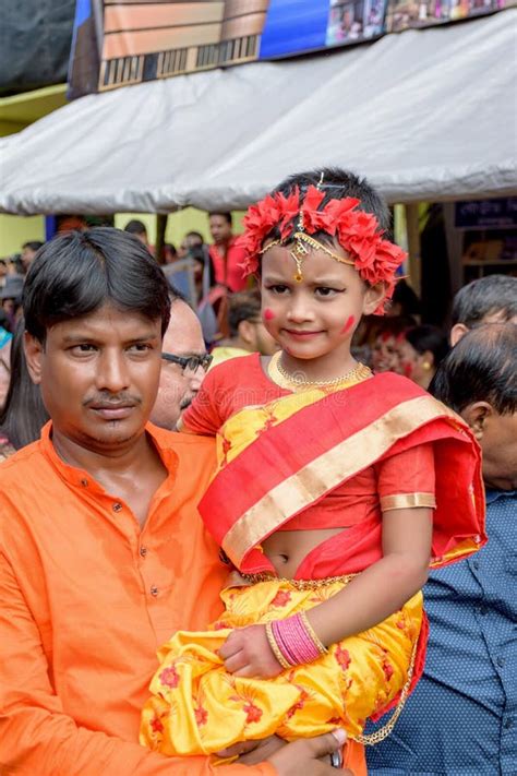 A Girl With His Father Participates In Sindur Khela At A Puja Pandal On