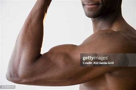 African American Man Flexing Biceps Photos And Premium High Res