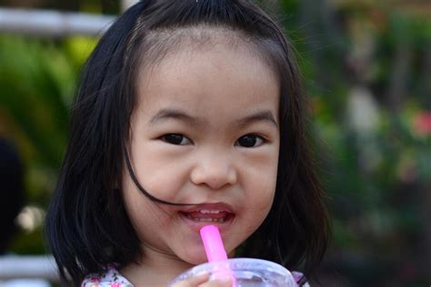 Premium Photo Portrait Of Cute Girl Drinking Outdoors