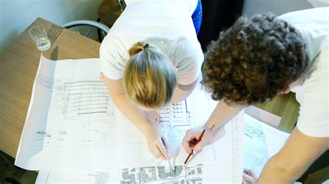 Male And Female Architects During Work With Construction Schemes Stock Video At Vecteezy