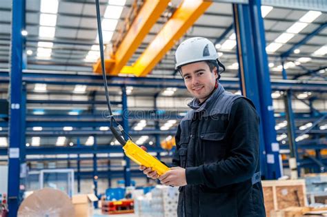 Engineer Controlling An Industrial Crane With Control Remote Stock