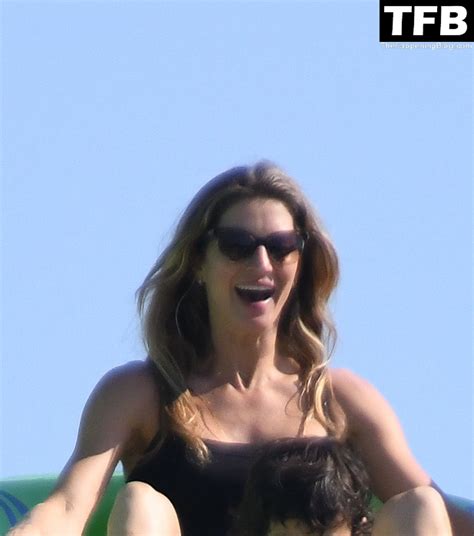 Gisele Bundchen Wears A Black Swimsuit As She Goes Down A Waterslide In