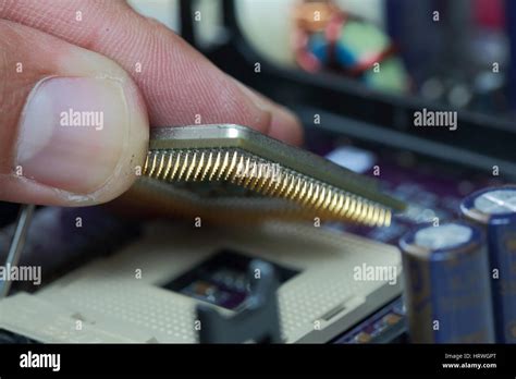 Selective Focus Of Plug In CPU Microprocessor To Motherboard Socket Mainboard Computer Stock