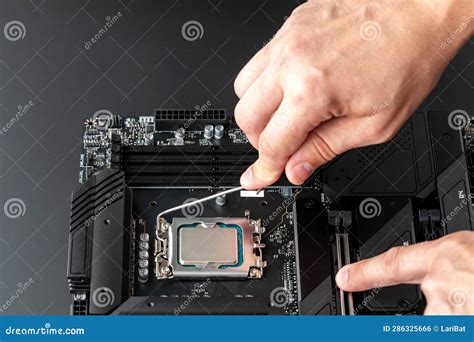 Computer CPU Installation Hand Of Master Installs Processor Chip On Computer Motherboard
