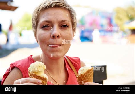 Pretty Blond Woman With Ice Cream In The Park Stock Photo Alamy
