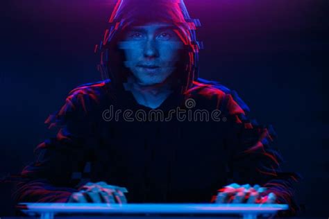 Hacker In The Hood Working With Computer Typing Text In Dark Room