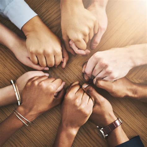 Community Trust And Friends Holding Hands By Table At Group Counseling