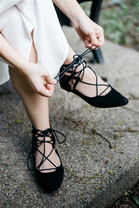 Woman Fixing Her Shoe Lace By Jessica Lia Stocksy United
