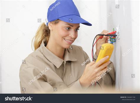 Female Electrician Testing Socket Using Multimeter Stock Photo Shutterstock