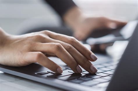 Premium Photo A Close View Of A Womans Hands Typing On A Modern Laptop Keyboard Office
