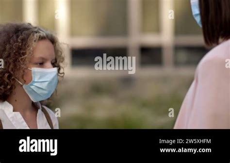 Teacher Woman Measures School Girl Temperature With Digital Thermometer
