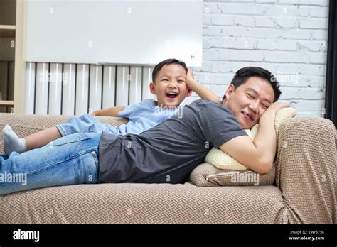 Intimate Father And Son Lying Together On The Sofa Stock Photo Alamy