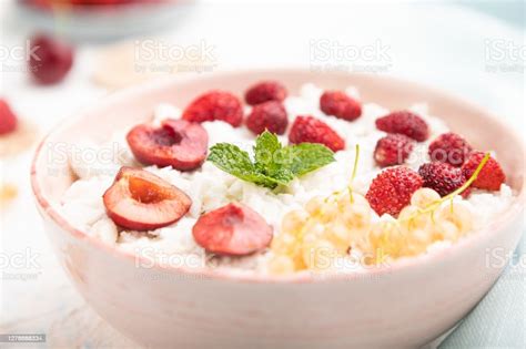 쌀은 흰색 콘크리트 배경과 파란색 린넨 직물에 세라믹 그릇에 우유와 딸기 죽을 조각 측면 보기 클로즈업 선택적 초점 0명에 대한 스톡 사진 및 기타 이미지 Istock