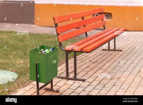 Garbage Bins In The Yard An Overflowing Urn Near The Entrance Of An Apartment Building Stock
