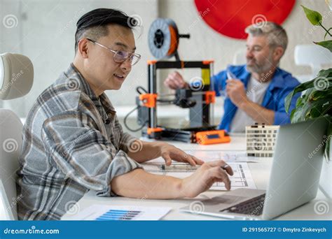 Architects Working With 3d Printer And Projecting House Model Drawing Blueprint Using Laptop