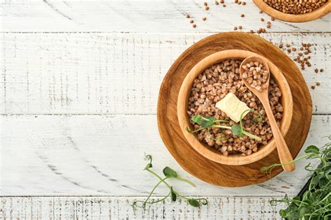 오래된 흰색 나무 배경에 파슬리 잎과 버터와 그릇에 메밀 죽 수제 음식 건강한 식단을 위한 글루텐 프리 고대 곡물 맨 위 보기입니다 공간을 복사합니다 0명에 대한 스톡 사진