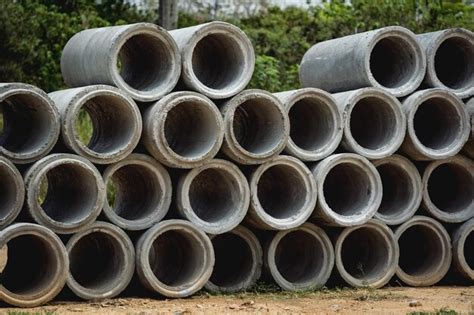 Premium Photo A Stack Of Concrete Ring Pipes Piled And Creating A Symmetrical Arrangement