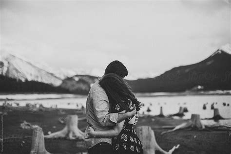 Adventurous Engaged Couple Hugging In Beautiful Mountain Landscape In