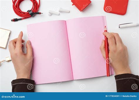 Open Notebook With Blank Pink Pages And Two Hands Concept Of Writing A Plan Strategy Stock