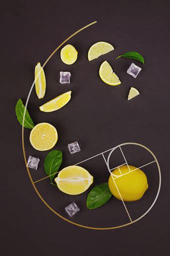 녹색 잎과 얼음 큐브와 노란색 레몬 라임 과일의 신선한 조각은 황금 비율의 형태로 갈색 배경에 배치 0명에 대한 스톡 사진 및 기타 이미지 Istock