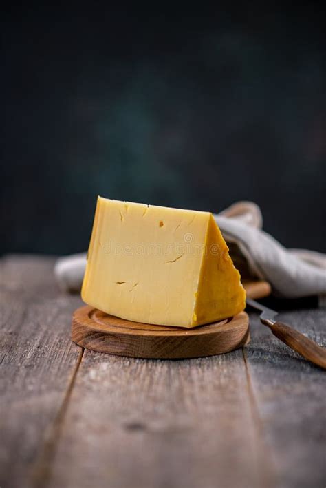 Medium Hard Cheese Head Edam Gouda Parmesan On Wooden Board With Knife