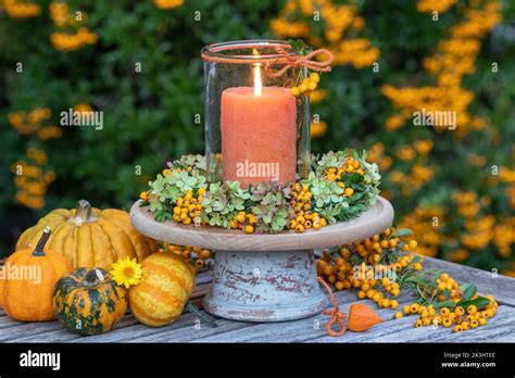 Fall Arrangement With Candle And Wreath Of Firethorn Berries Hydrangea