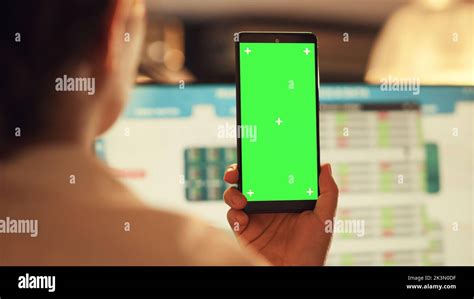 Female Manager Using Smartphone With Greenscreen Display Analyzing