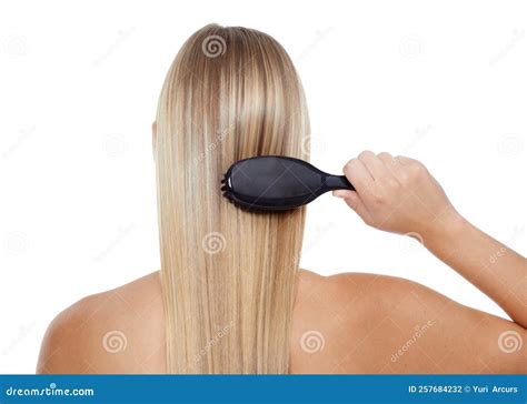 Combing Her Hair To Keep It Healthy A Gorgeous Young Woman Showing Off