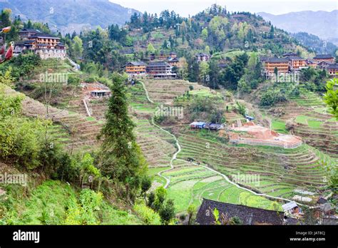 Travel To China Above View Of Dazhai Village On Terraced Green Hills