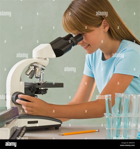 Girl Using Microscope Stock Photo Alamy