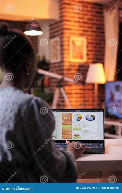 Business Analyst Looking At Diagrams And Pie Charts On Laptop Screen