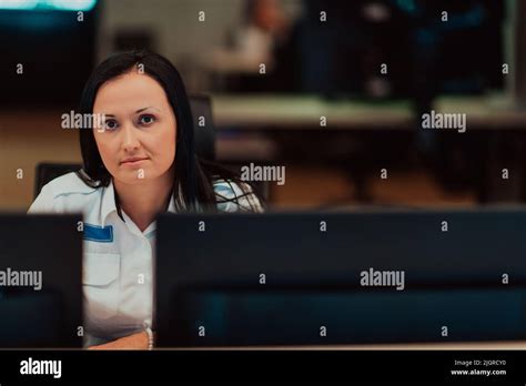 Female Security Operator Working In A Data System Control Room Offices Technical Operator