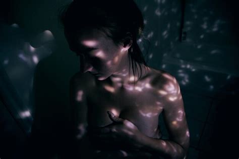 Premium Photo High Angle View Of Sensuous Naked Woman Covering Breasts In Darkroom