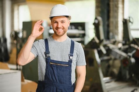 Premium Photo Smiling And Happy Employee Industrial Worker Indoors In Factory Young Technician