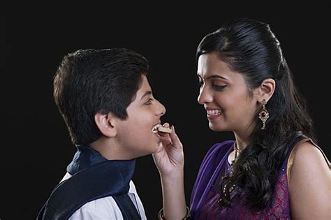 Sister Feeding Sweets To Her Brother At Bhaidooj Photo Background And