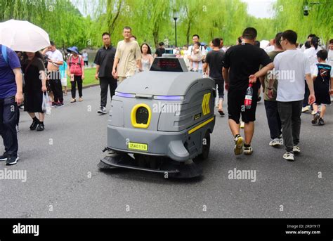 An Intelligent Sweeping Robot Works At The Bai Causeway In The West Lake Scenic Spot Drawing