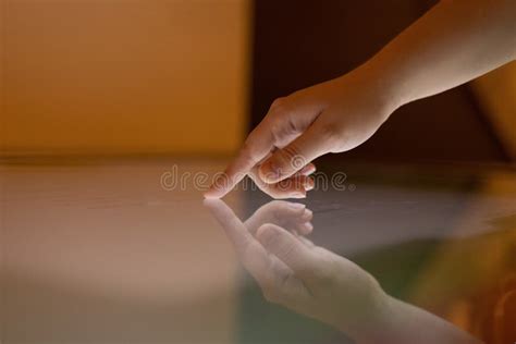 Woman Using Interactive Touchscreen Display Table At Urban Exhibition