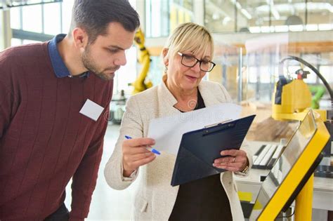 Engineers Discussing Robotics Programming And Automation In A Modern