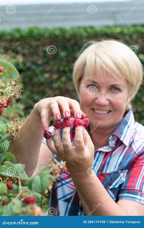 A Woman Put Raspberries On Her Fingers And Shows Her Original Berry Manicure Stock Photo Image