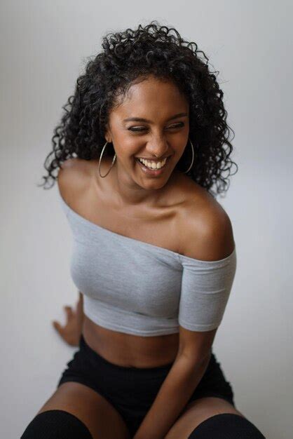 Premium Photo Portrait Of A Beautiful Dark Skin Woman With Long Curly Hair Smiling