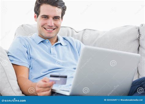 Portrait Of A Man Using His Credit Card To Purchase Online Stock Image Image Of Lounge