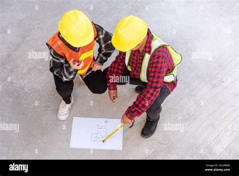 architect and client discuss help create plan with blueprint of the