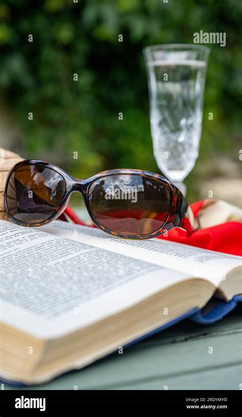 Summer Iconic Scene Of A Hot Lazy Summers Day A Sun Hat Book A Glass Of Champagne And