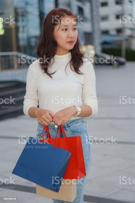 쇼핑몰에서 쇼핑백과 스마트폰을 들고 있는 여성 쇼핑센터에서 행복한 쇼핑 Brand Name Mobile Payment에 대한 스톡 사진 및 기타 이미지 Brand