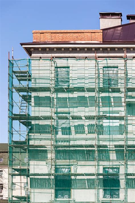 Scaffolding With Green Safety Net Near Building Facade Stock Image Image Of Equipment Metal