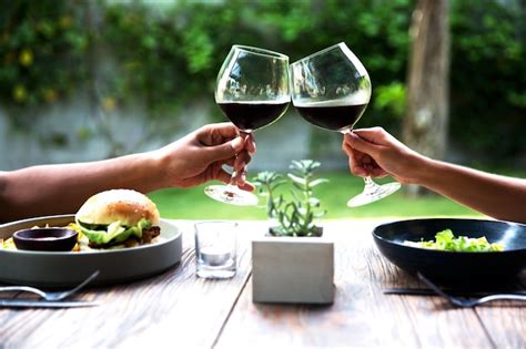Premium Photo Two Persons Clinking Glasses Of Red Wine