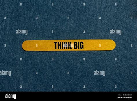 Think Big Message Written On Yellow Wooden Stick With Gray Background Conceptual Think Big