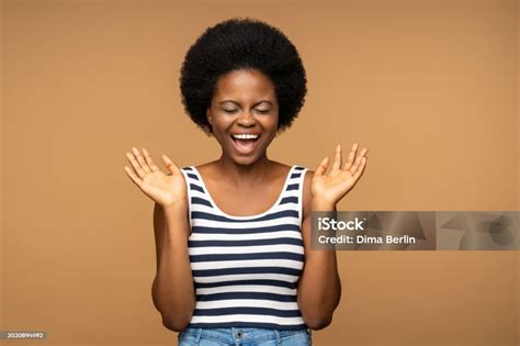 Emotional Overjoyed Black Female Smiling Broadly With Eyes Closed Of