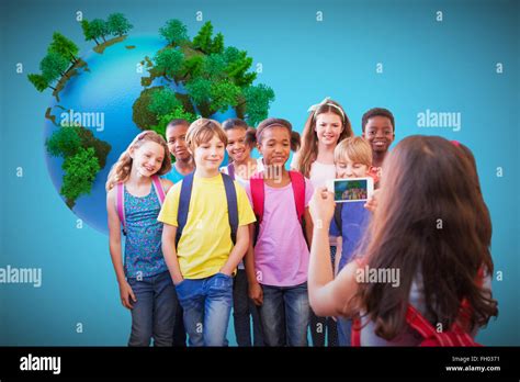 Composite Image Of Cute Pupils Using Mobile Phone Stock Photo Alamy